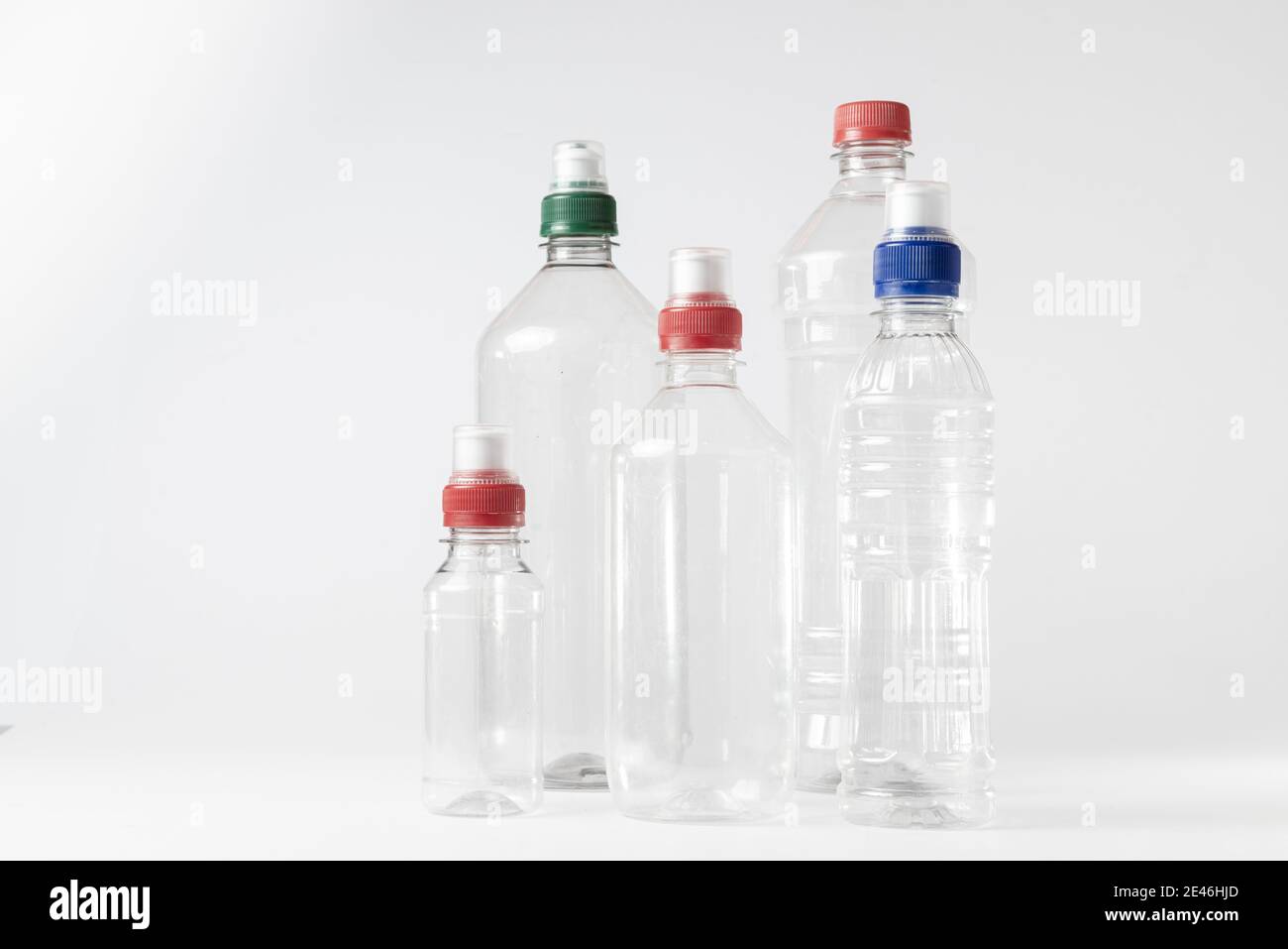 Isolated shot of empty plastic bottles of various sizes on white ...