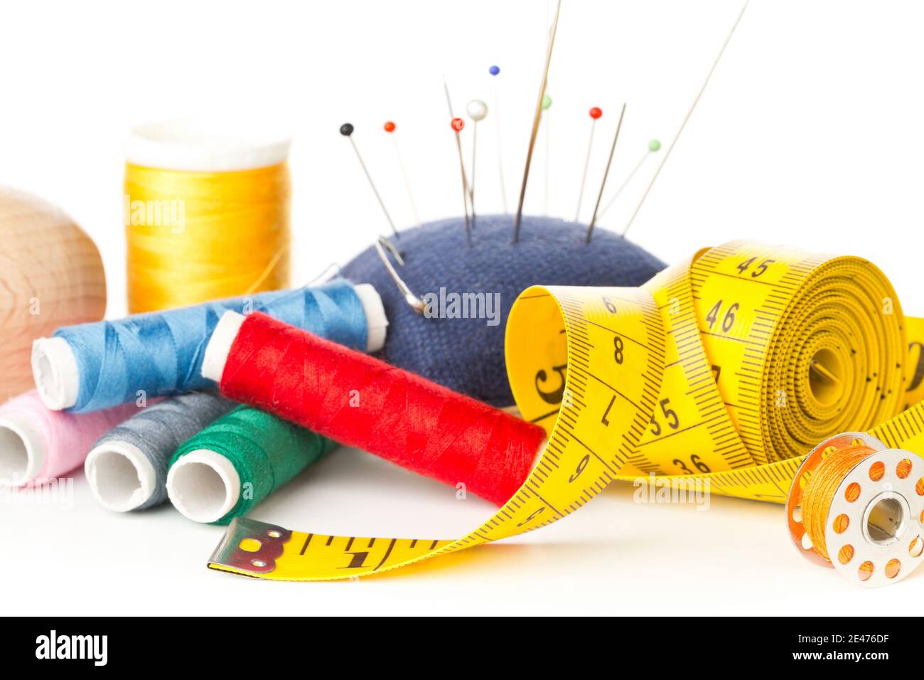 Close up of collection of sewing tools with yarn, needles, scissors and ...