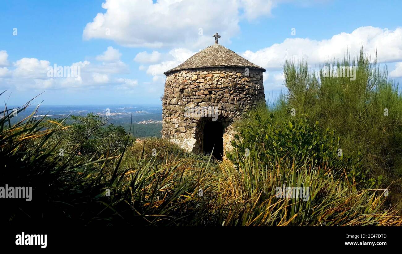 View of a stone chapel with greenery on a hill Stock Photo - Alamy