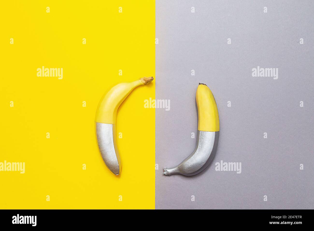 Painted silver bananas on a yellow-gray background. Minimalistic ...