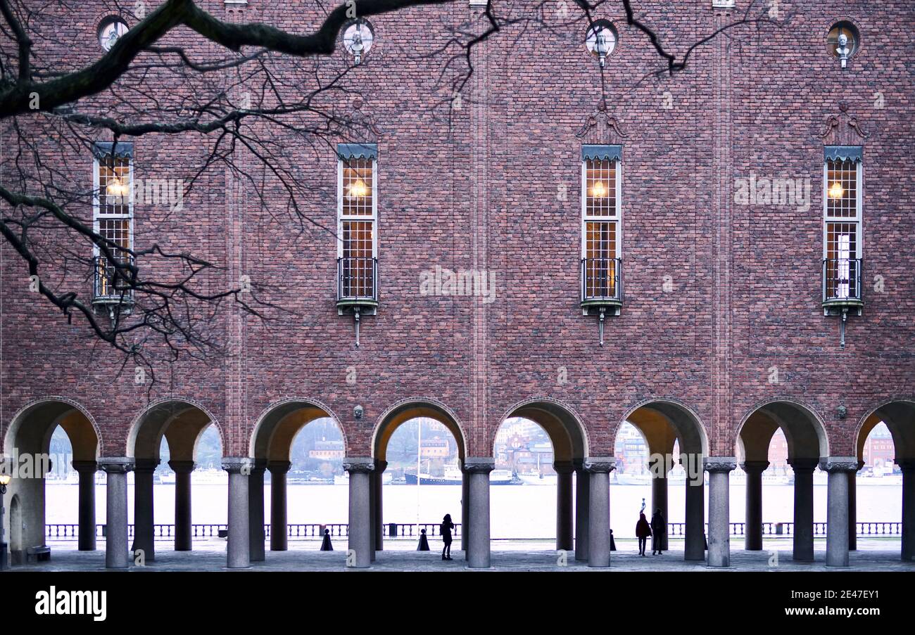 Beautiful view of a building with arches underneath allowing people to ...