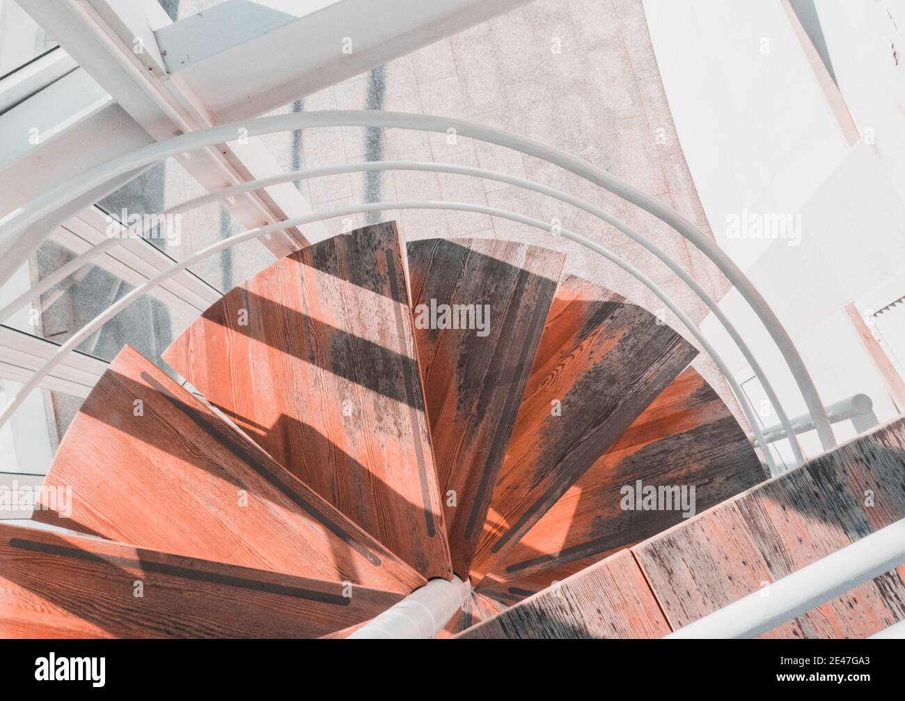 Top view of a round wooden staircase with white railings Stock Photo ...