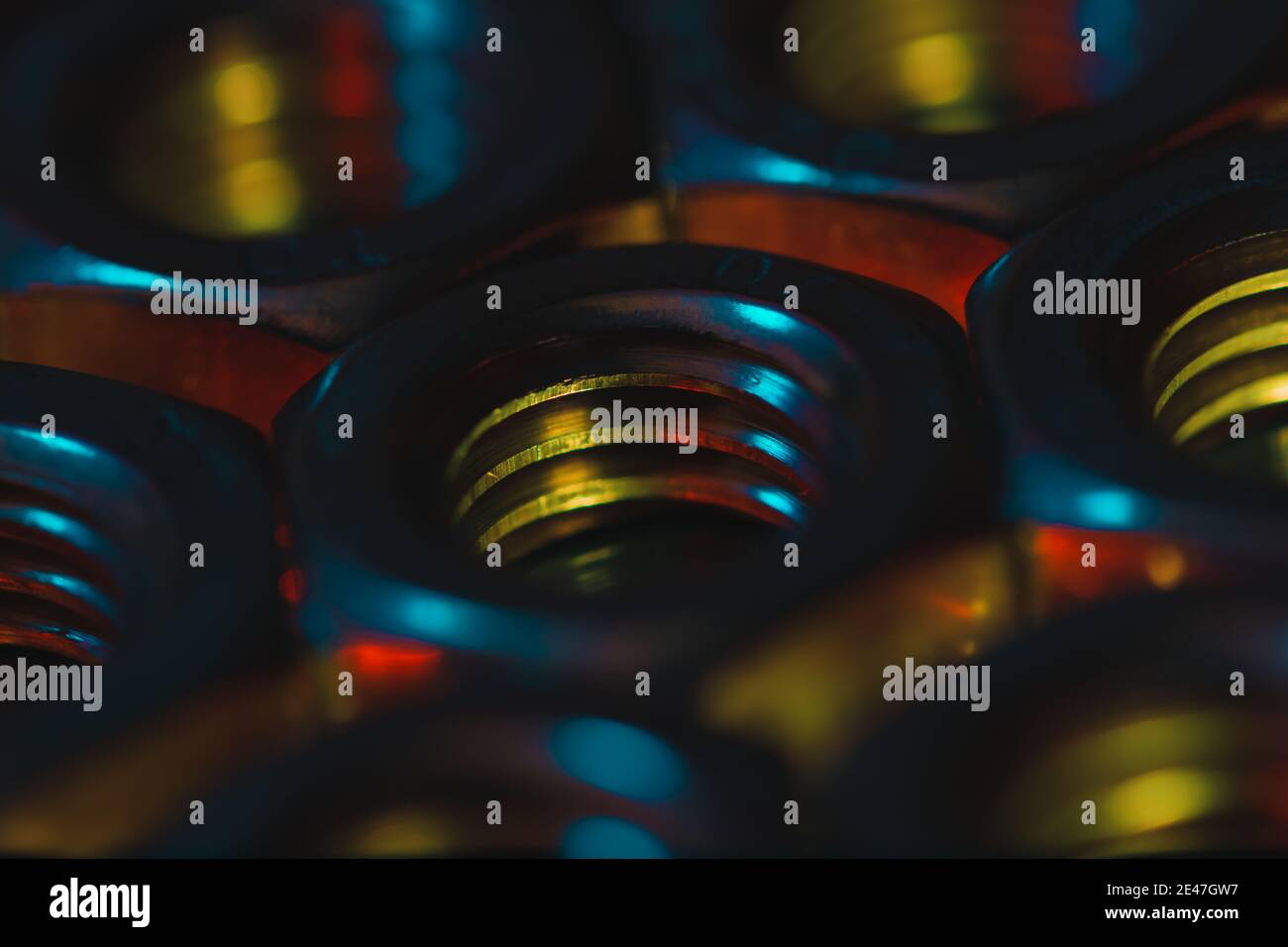 Screw nuts in a dark atmosphere with the red light coming under it ...