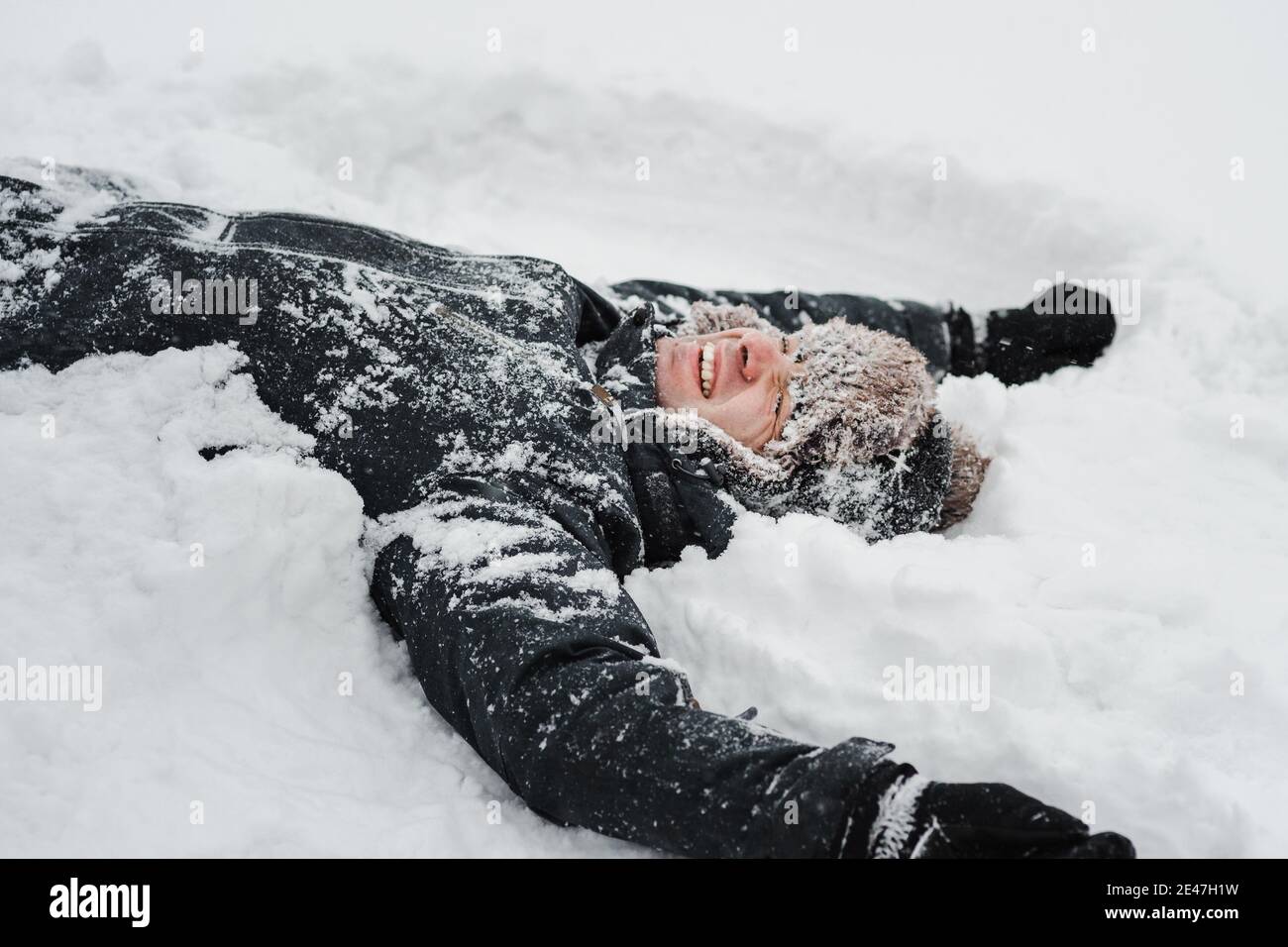 Man are lying in the snow in winter Stock Photo - Alamy
