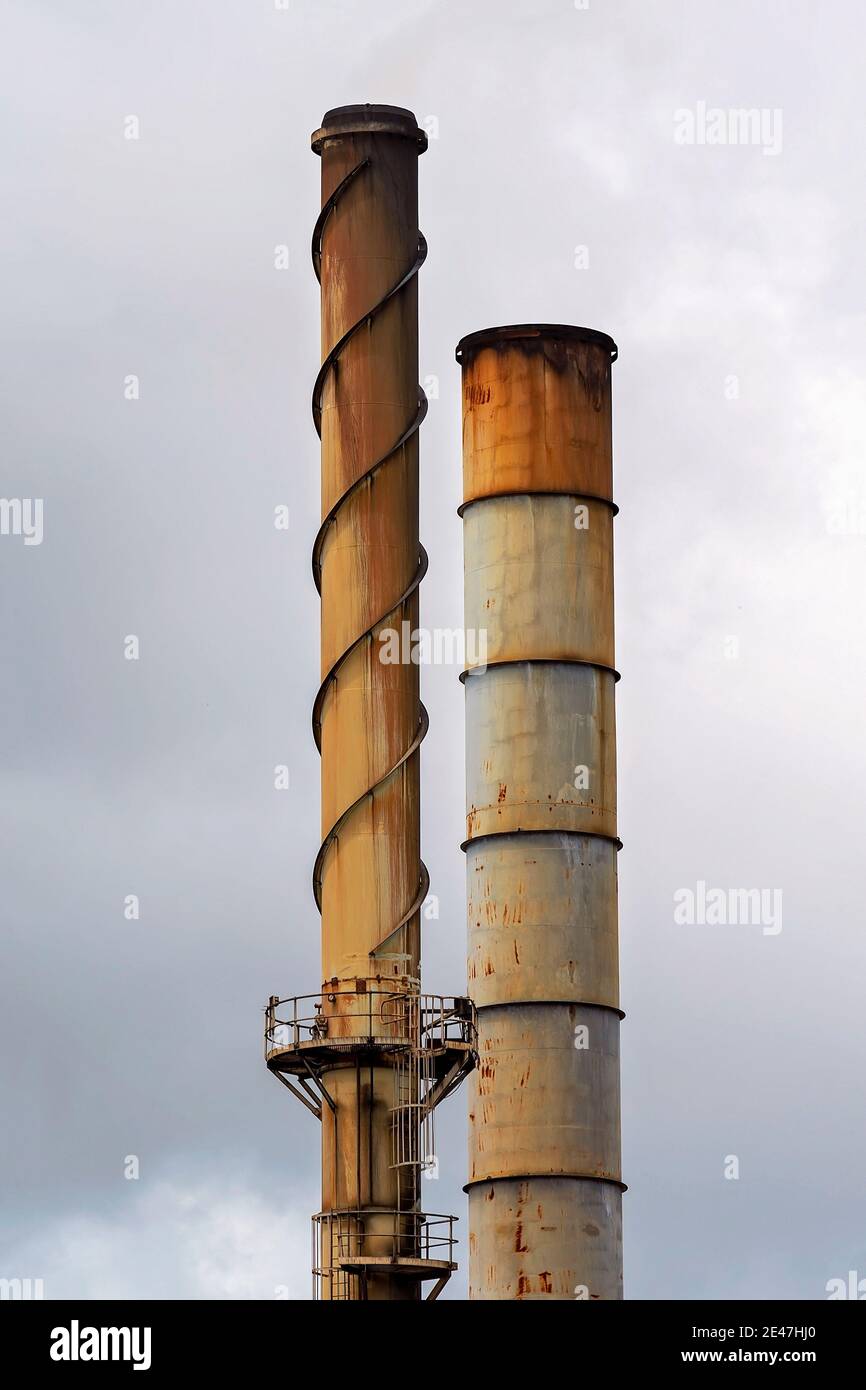 Chimney stacks of an industrial mill which crushes sugar cane. Grey ...