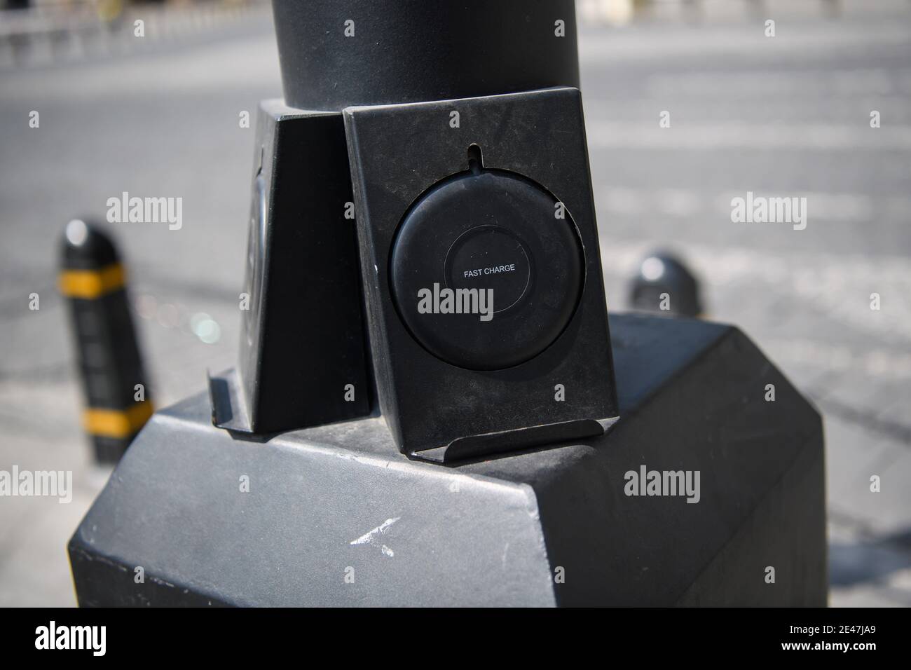 A gadget provides wireless charging for smartphone of pedestrians are ...