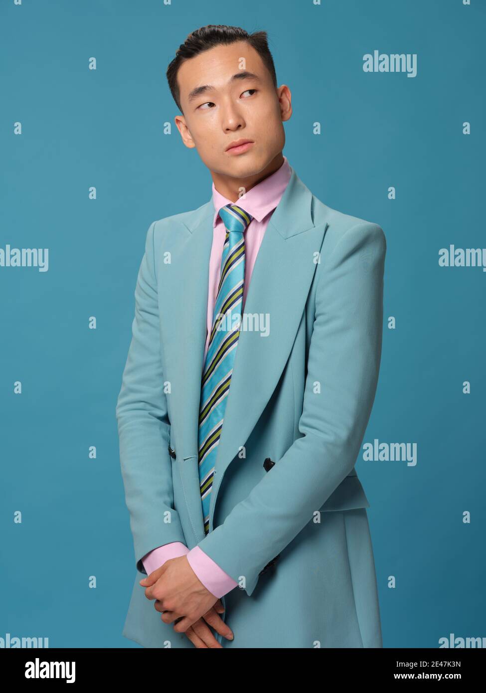 man of asian appearance in business suit lifestyle blue background ...