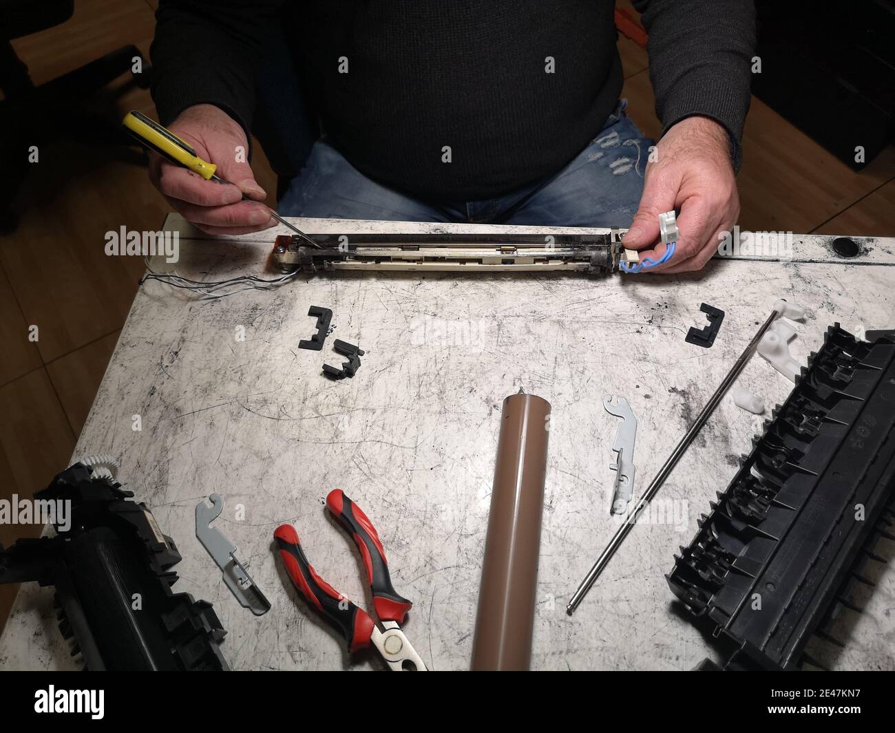 Closeup of the male technician's hands repairing the printer Stock ...