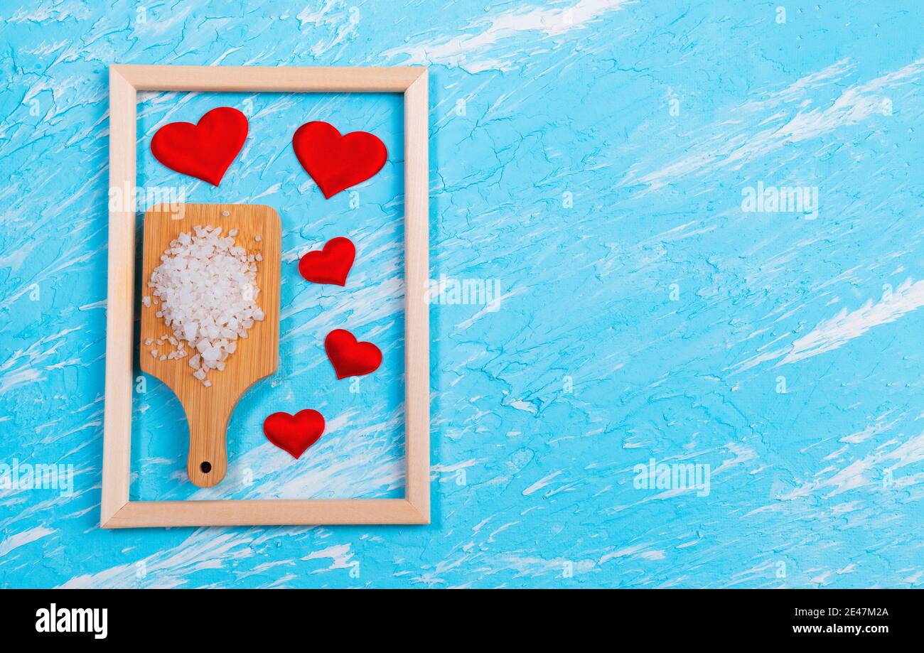 sea salt for food love heart on blue background with space to copy text ...