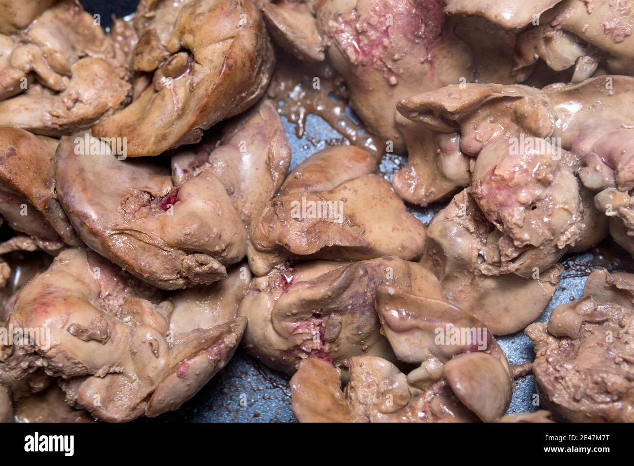 Cooking fried liver in a frying pan close-up. selective focus Stock ...