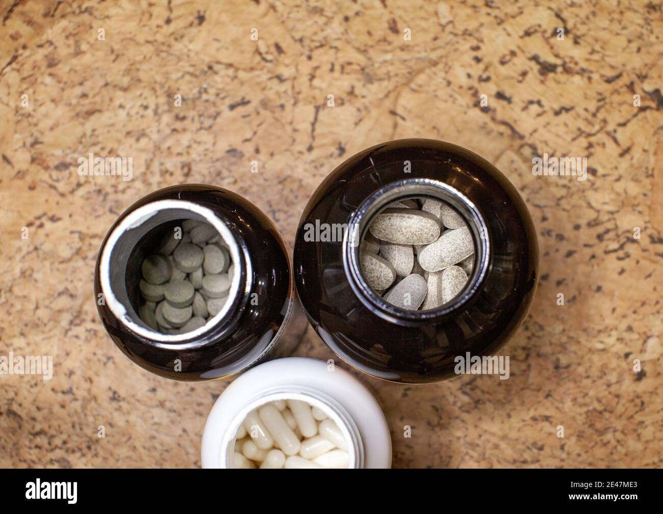 Various capsules and tablets with food additives or medicines in a jar ...