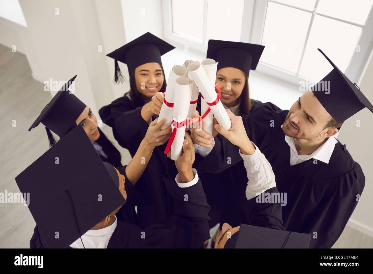 Graduates raise up diplomas hi-res stock photography and images - Alamy