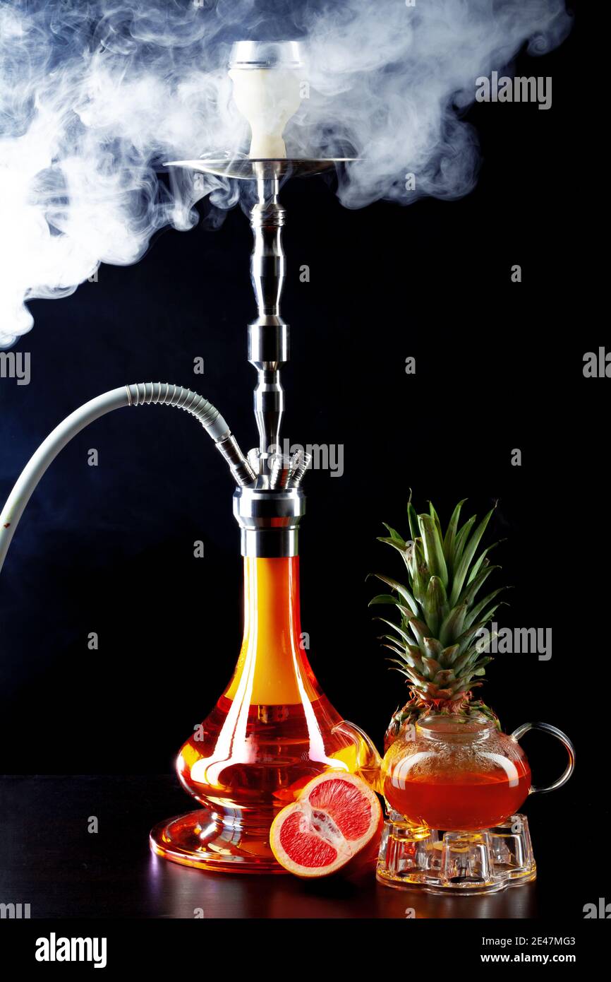 Modern shisha and glass teapot on black background Stock Photo - Alamy