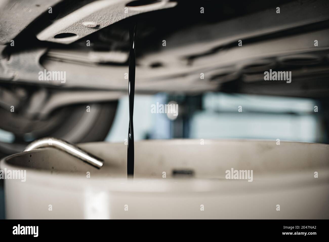 Old oil pouring from the car engine Stock Photo - Alamy