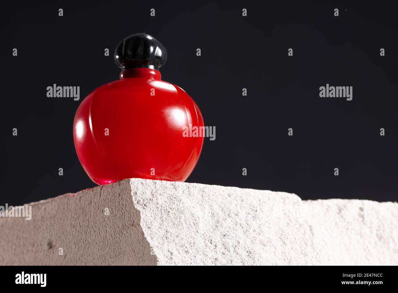 Bottle of perfume on cinder block close up Stock Photo - Alamy