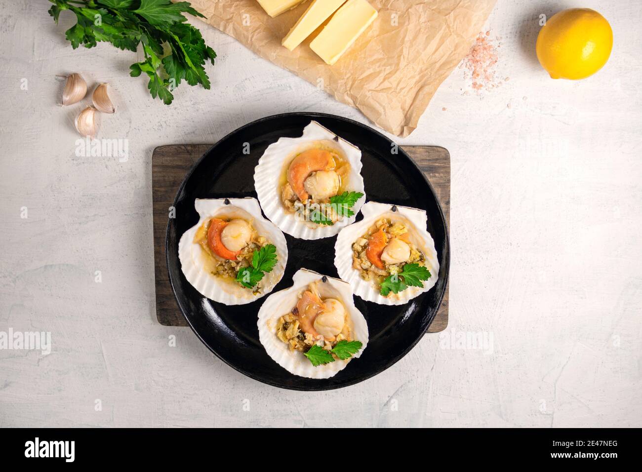 Baked scallops with caviar and creamy garlic sauce. Scallops, lemon ...
