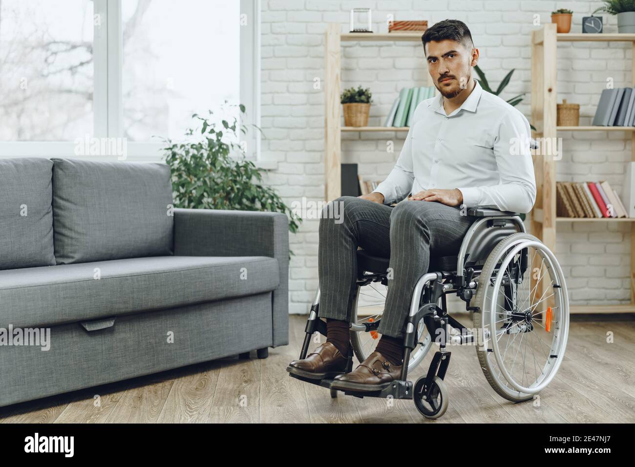 Portrait of disabled man in formal wear sitting in a wheelchair Stock ...