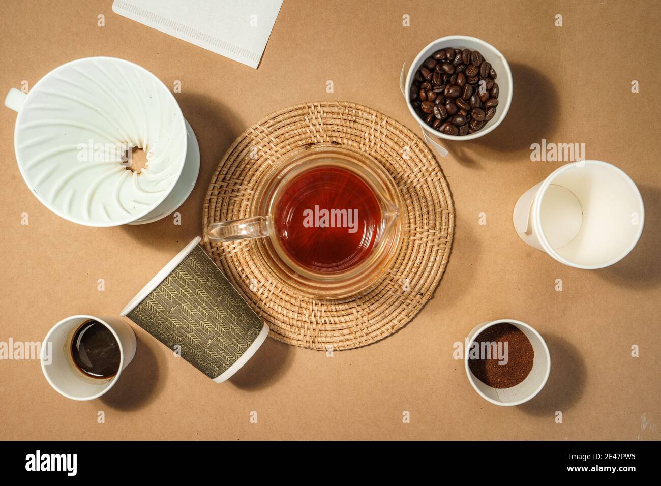 Coffee dripper,Drip paper and coffee drip jar On a brown background ...