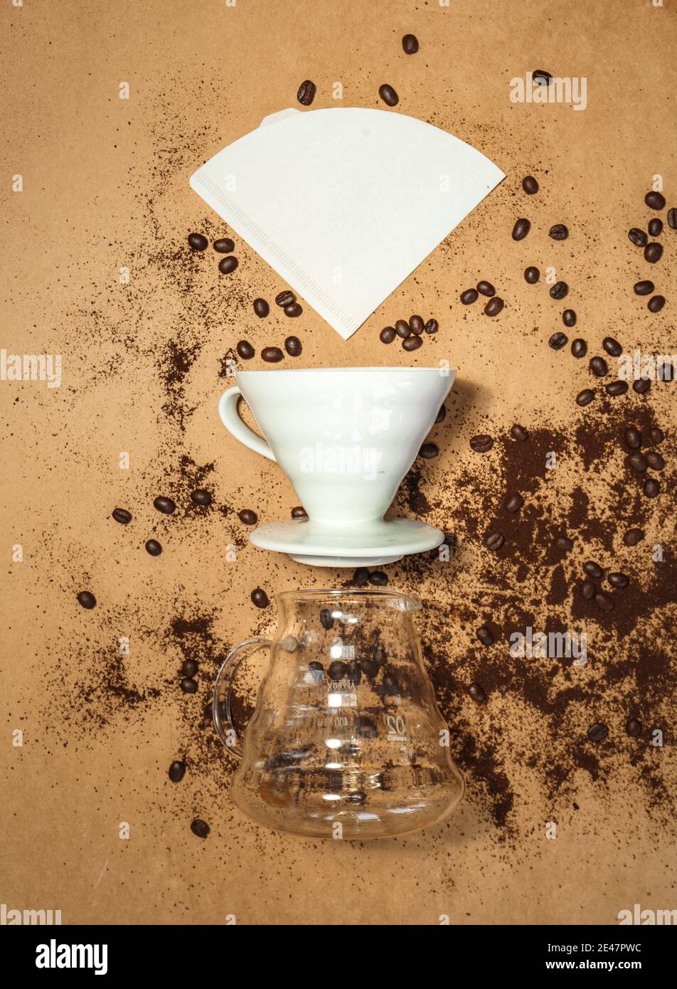 Coffee dripper,Drip paper and coffee drip jar On a brown background ...