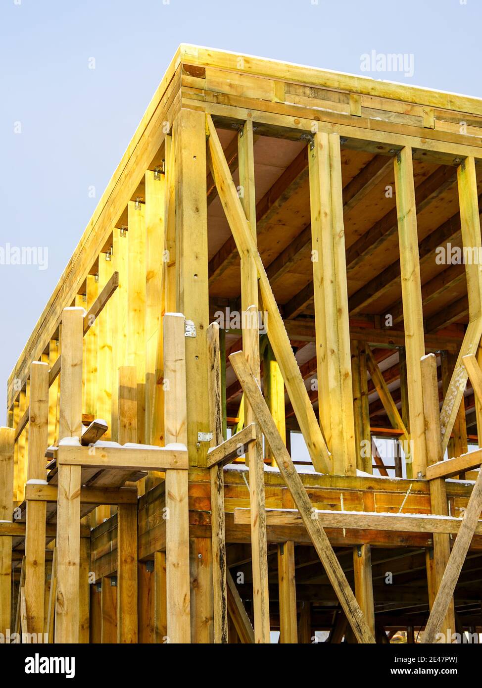 structure of a natural wooden house under construction, blue sky ...