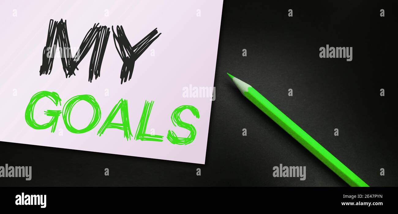 my goals text written on paper and orange pencil. Business and personal ...