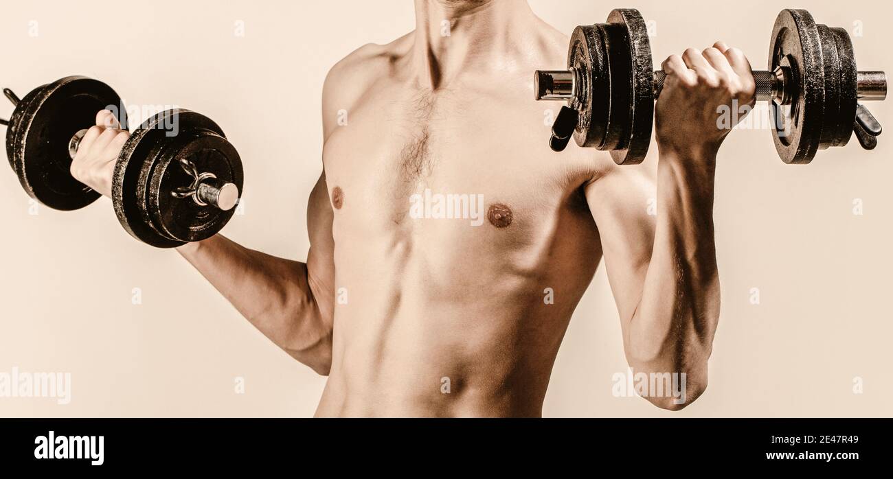 Man in sports with dumbbells. Weak man lift a weight, dumbbells, biceps ...