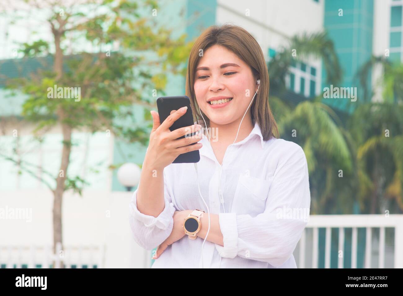 Asian women use mobile smartphone to shopping online at home outdoor ...