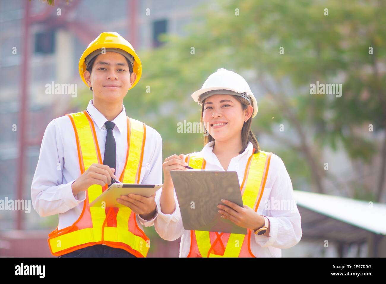 Two people Asian engineer use tablet talking check inspection plan in ...
