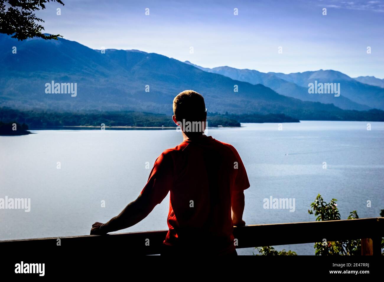 Silhouette of a man admiring the beautiful scenery of waters on ...