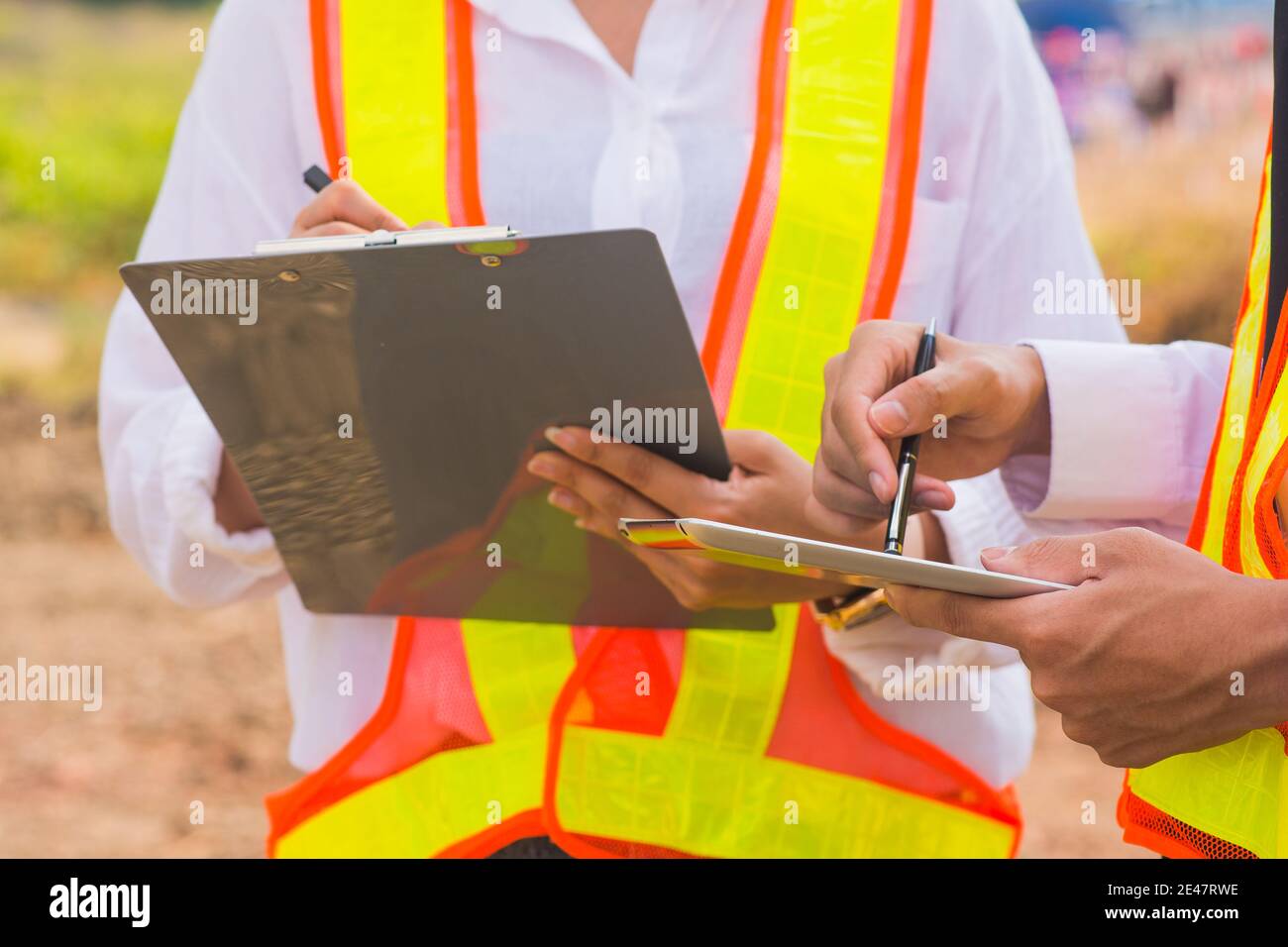 Two people Asian engineer use tablet talking check inspection plan in ...