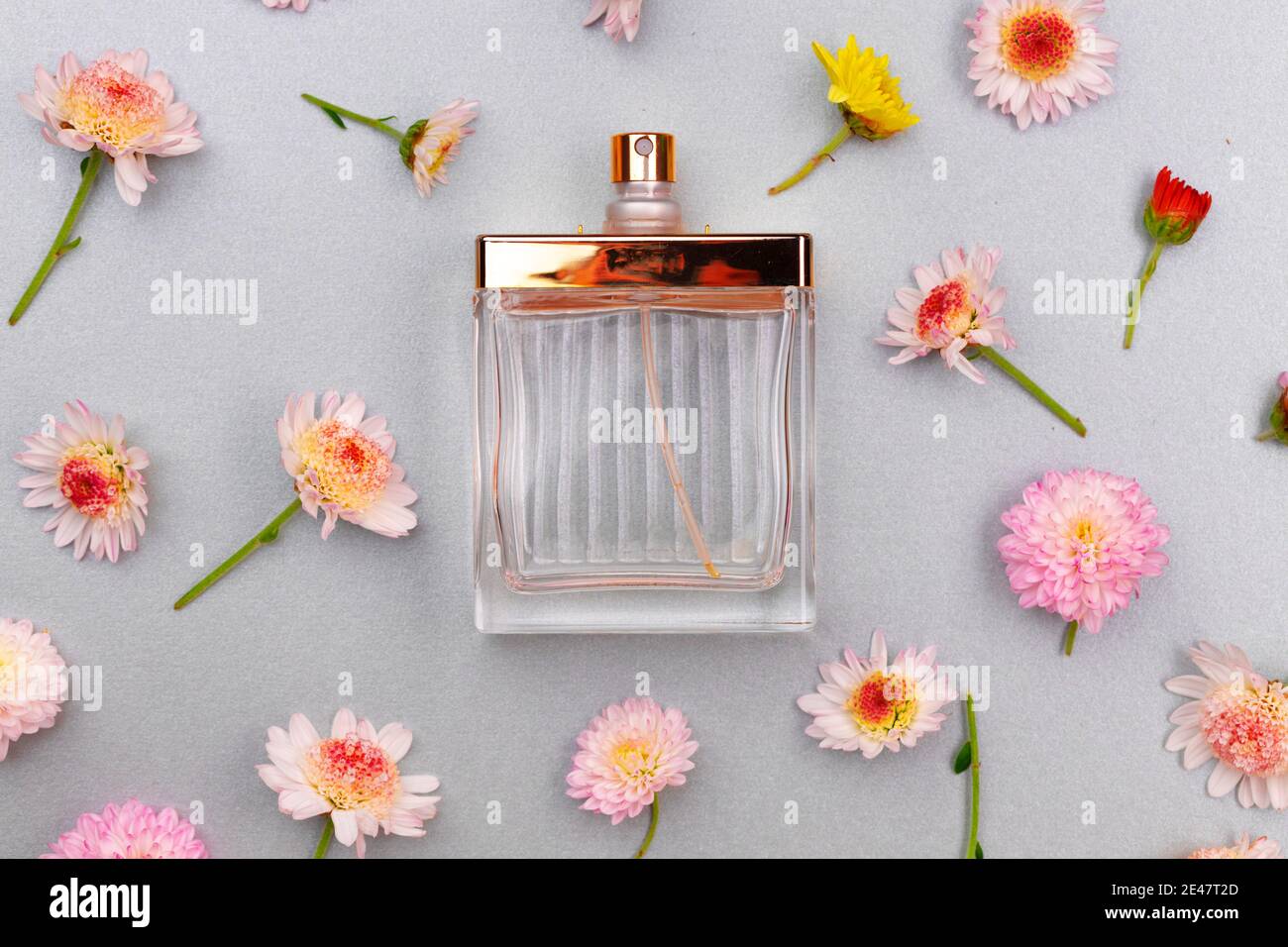 Bottle of fragrance surrounded by flower buds Stock Photo - Alamy