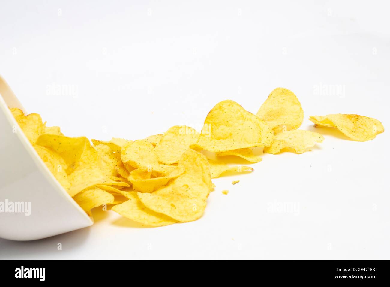 Potato chips falling into bowl isolated on white background Stock Photo ...