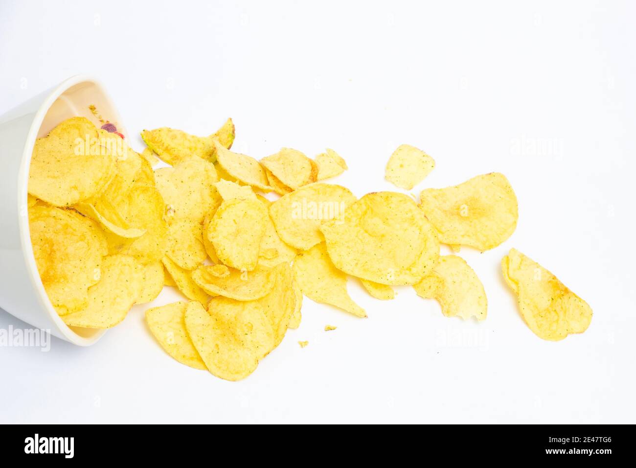 Potato chips falling into bowl isolated on white background Stock Photo ...