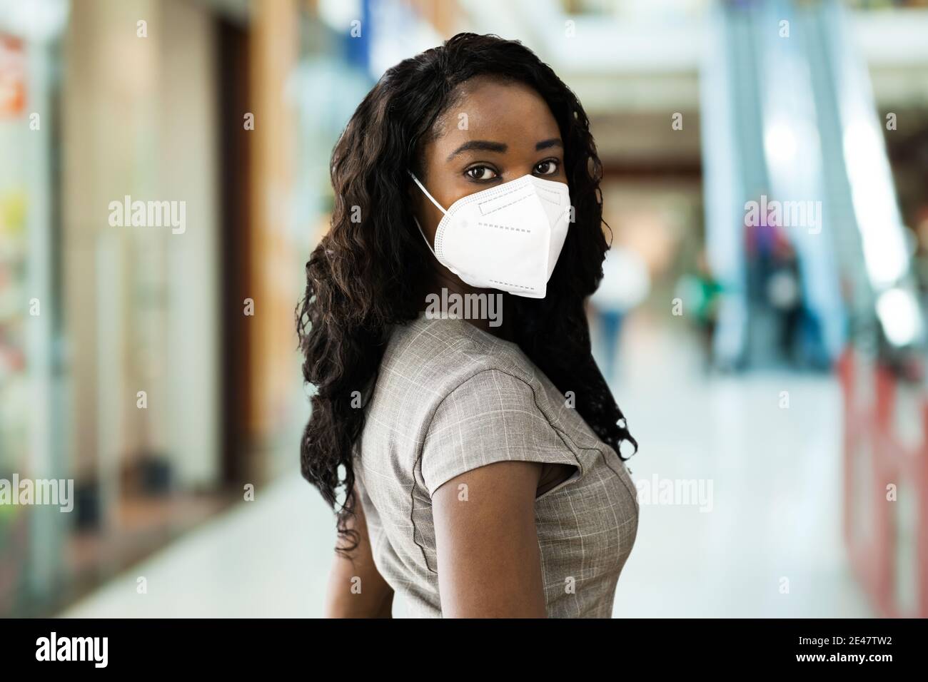 African American Woman Shopping In Mall Wearing Face Mask Stock Photo ...