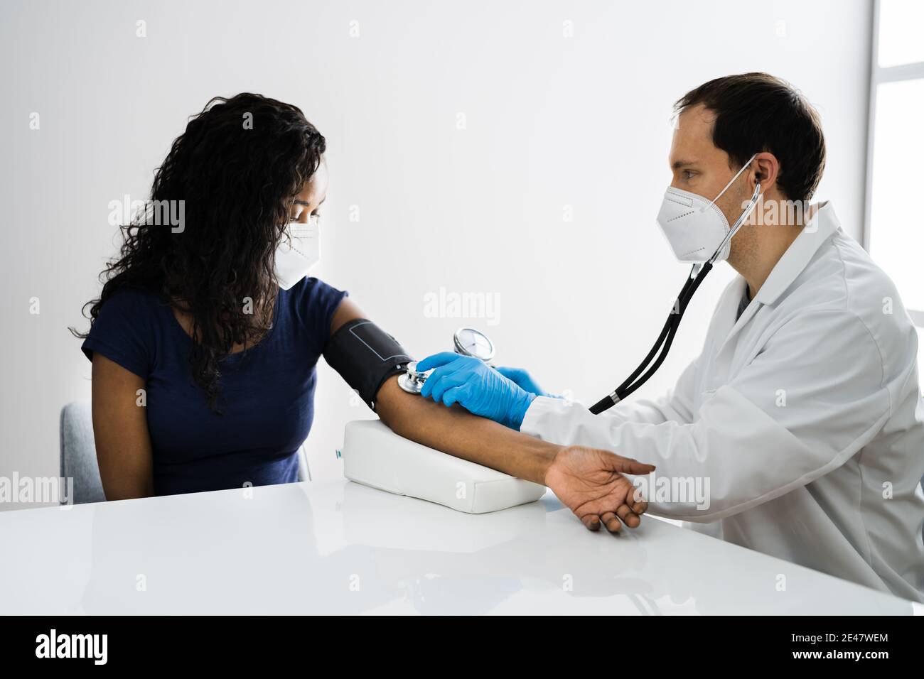 Doctor wearing medical uniform checking hi-res stock photography and ...