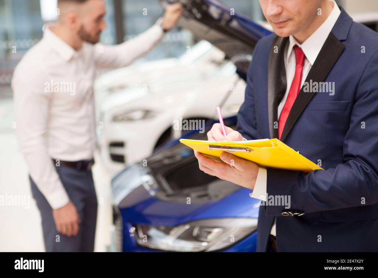 Signing papers at dealership hi-res stock photography and images - Alamy