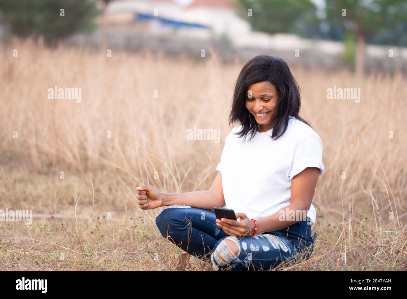 African lady sitting outside using hi-res stock photography and images ...