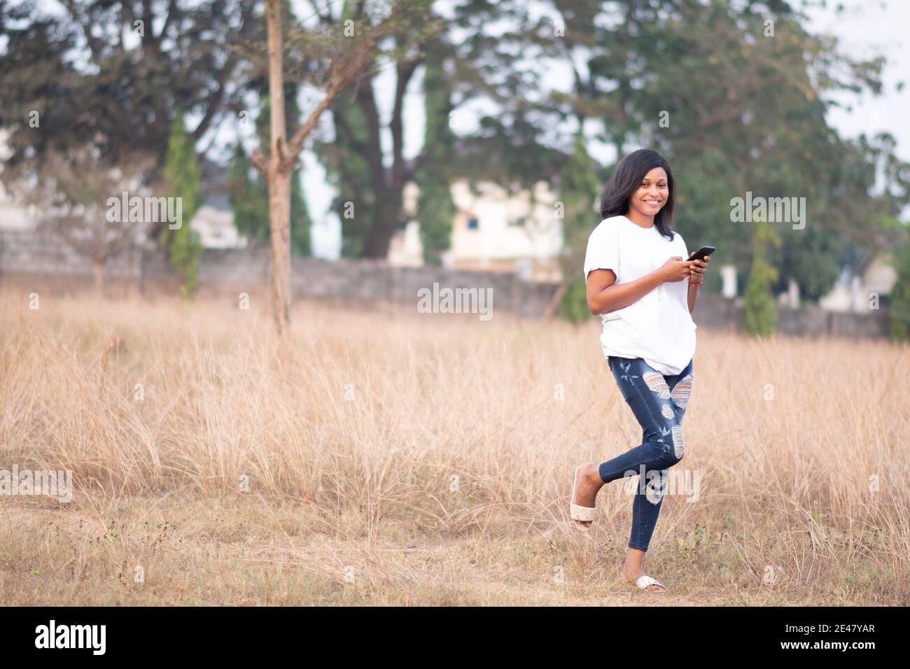 African lady walking hi-res stock photography and images - Alamy
