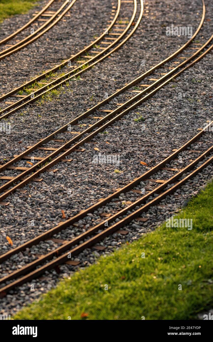 Vertical closeup shot of a railroad track lines with gravel in ...
