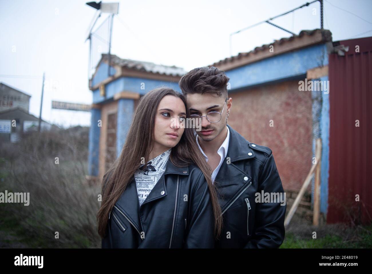 Portrait of a badass couple wearing leather jackets in the suburbs ...