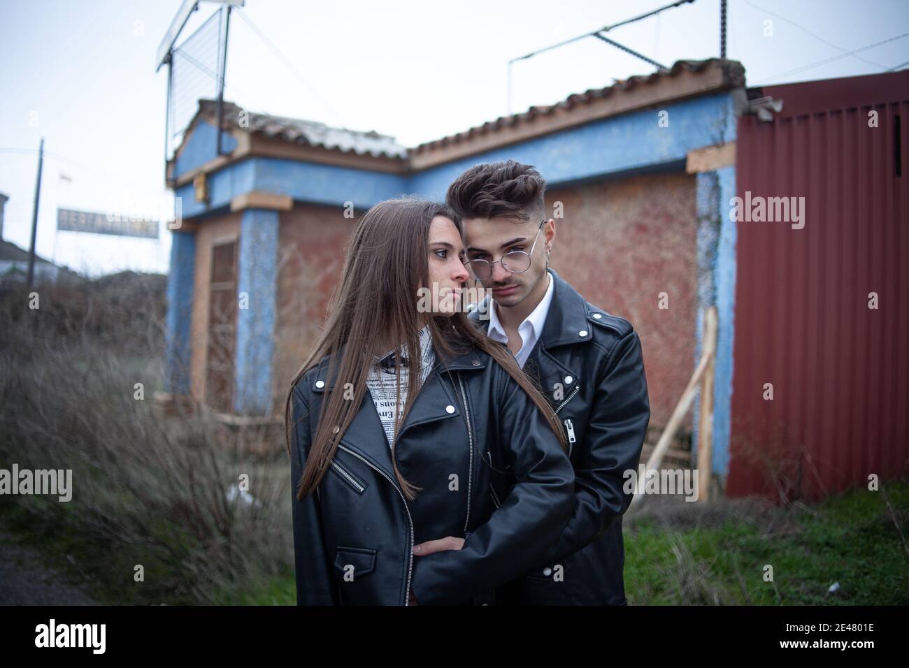 Portrait of a badass couple wearing leather jackets in the suburbs ...