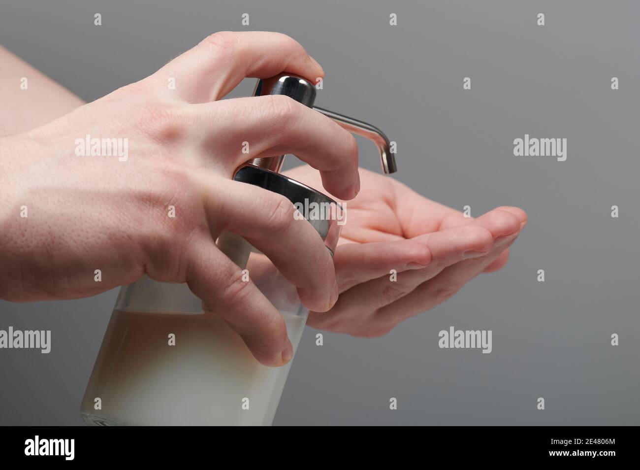 Pouring liquid soap on hand close up view isolated Stock Photo - Alamy