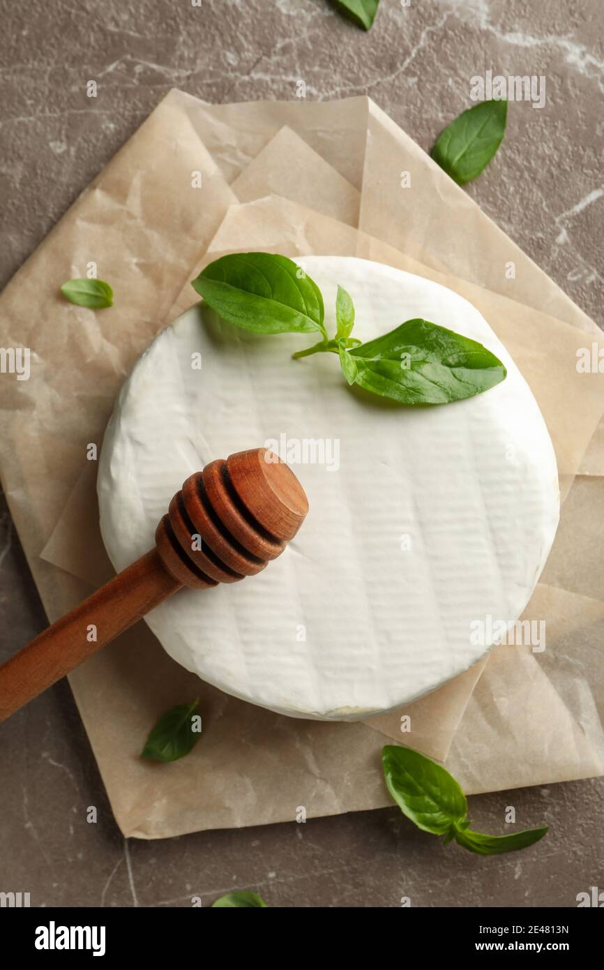 Baking paper with camembert, dipper and basil on gray background Stock ...