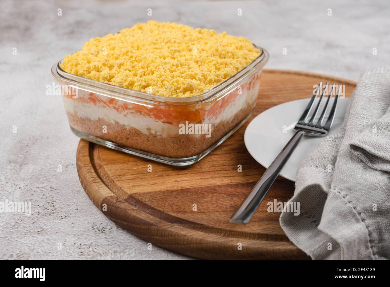 Layered salad with potatoes, tuna, carrot, onion, eggs and mayonnaise ...