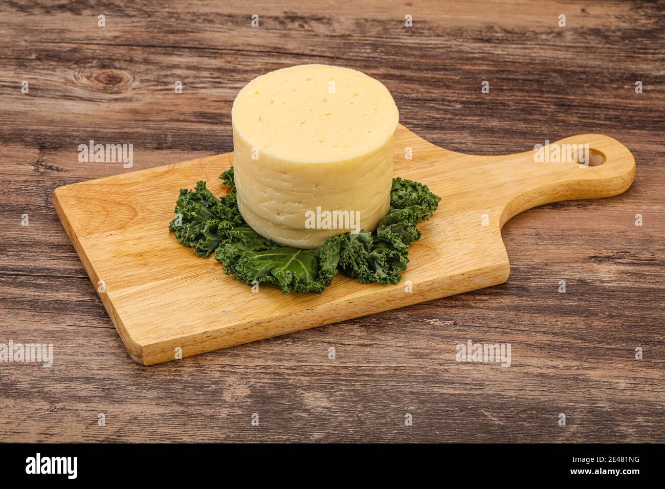 Yellow round dairy soft cheese piece Stock Photo - Alamy