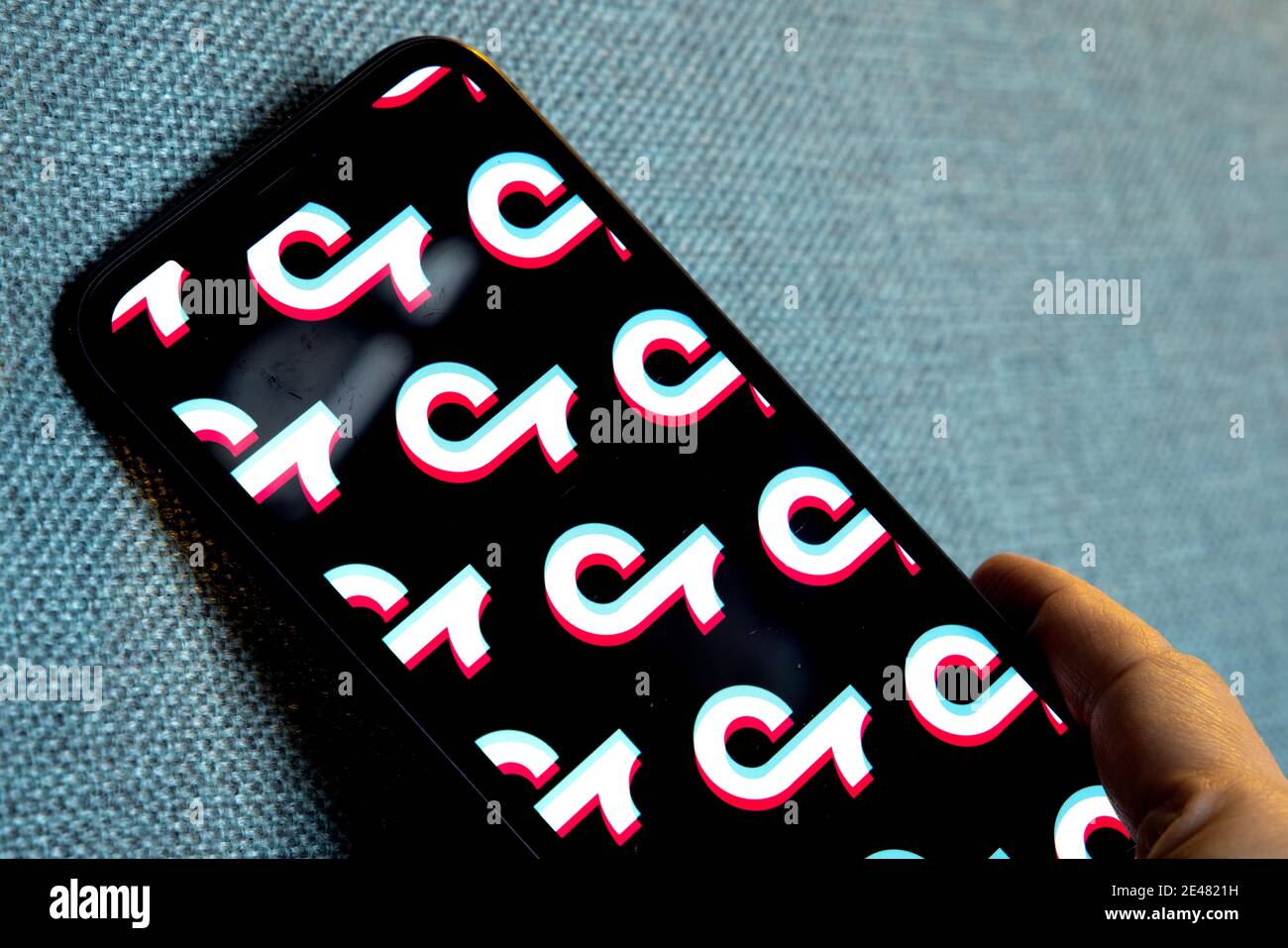 TikTok application icon on Apple iPhone 11 screen close-up. Hand ...