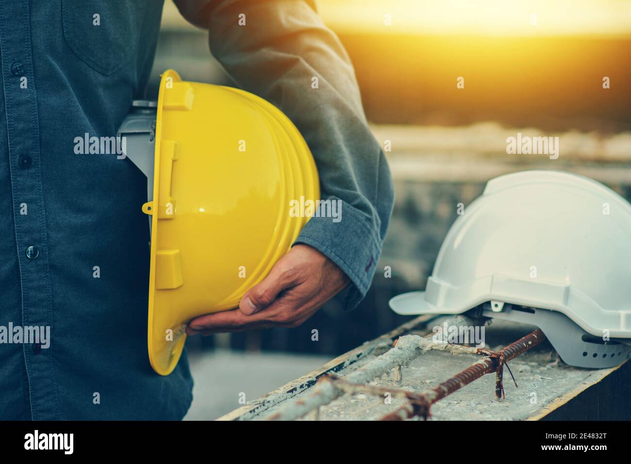 Close up Engineer holding hard hat on site construction Stock Photo - Alamy