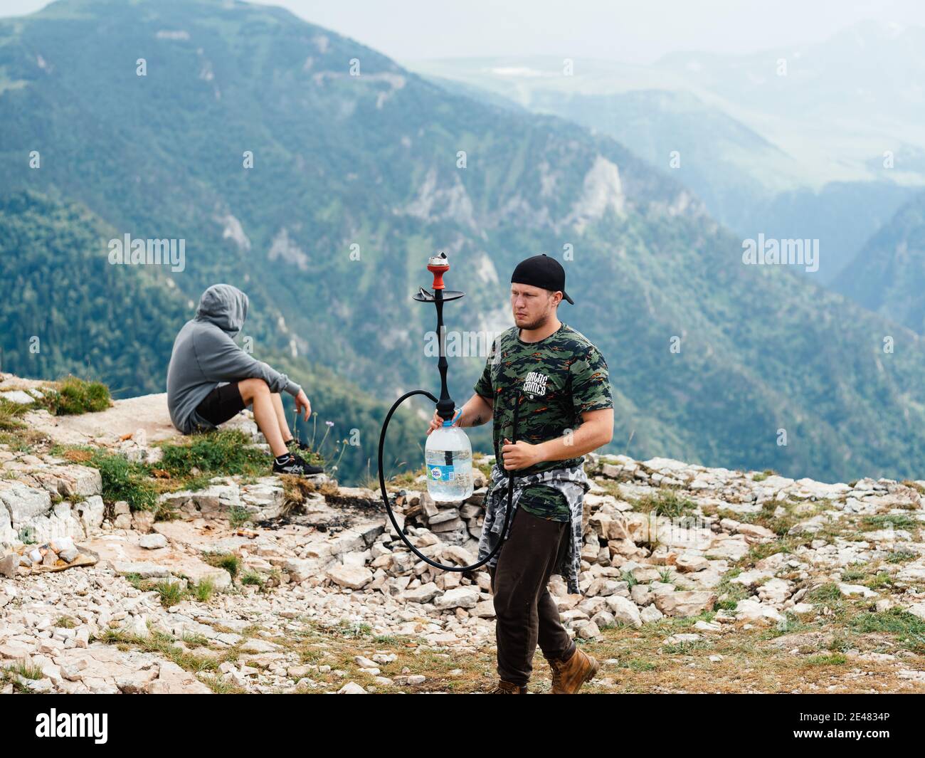 Man relax in the mountains on nature beautiful landscape fresh air fog ...