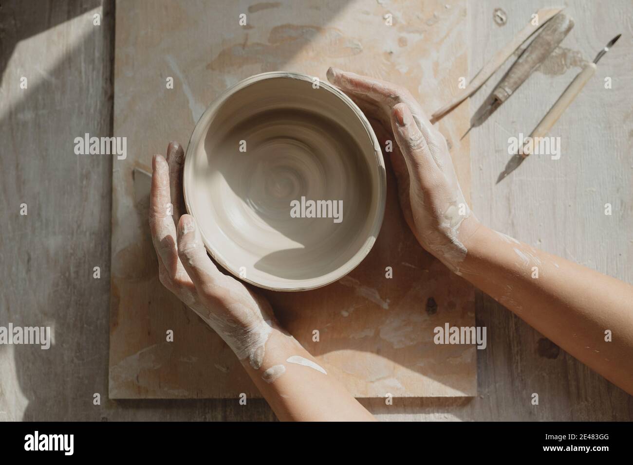 Hands of potter do a clay pot. Top view Stock Photo - Alamy
