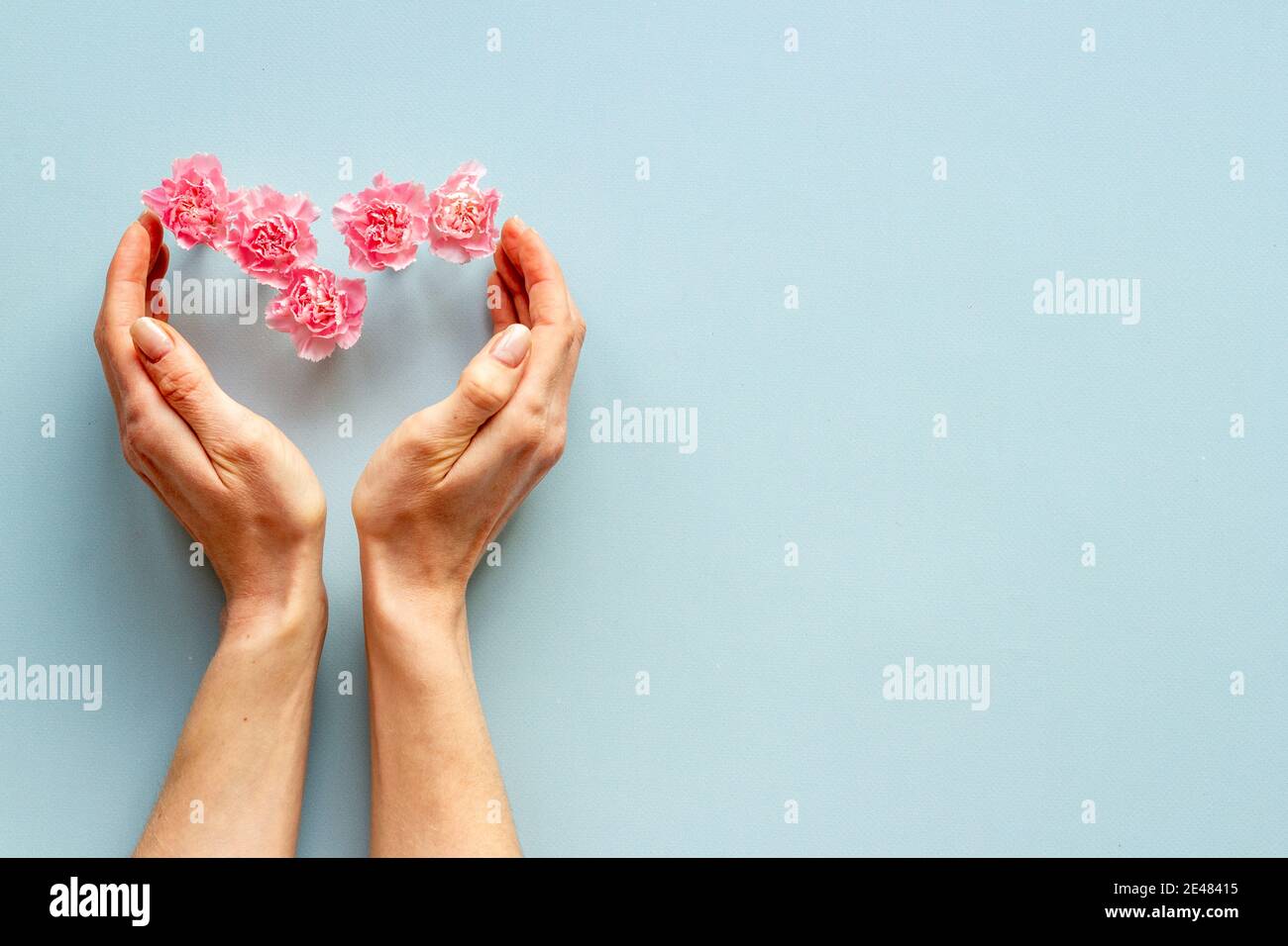 Heart shape of flowers with hands. Valentines Day, wedding or birthday ...